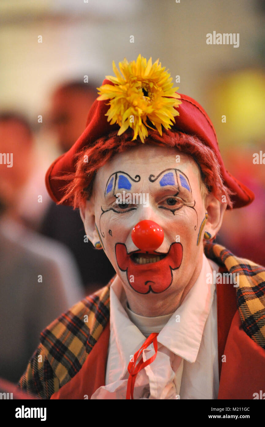 A clown wearing a sunflower singing at the 67th Annual Grimaldi Clown ...