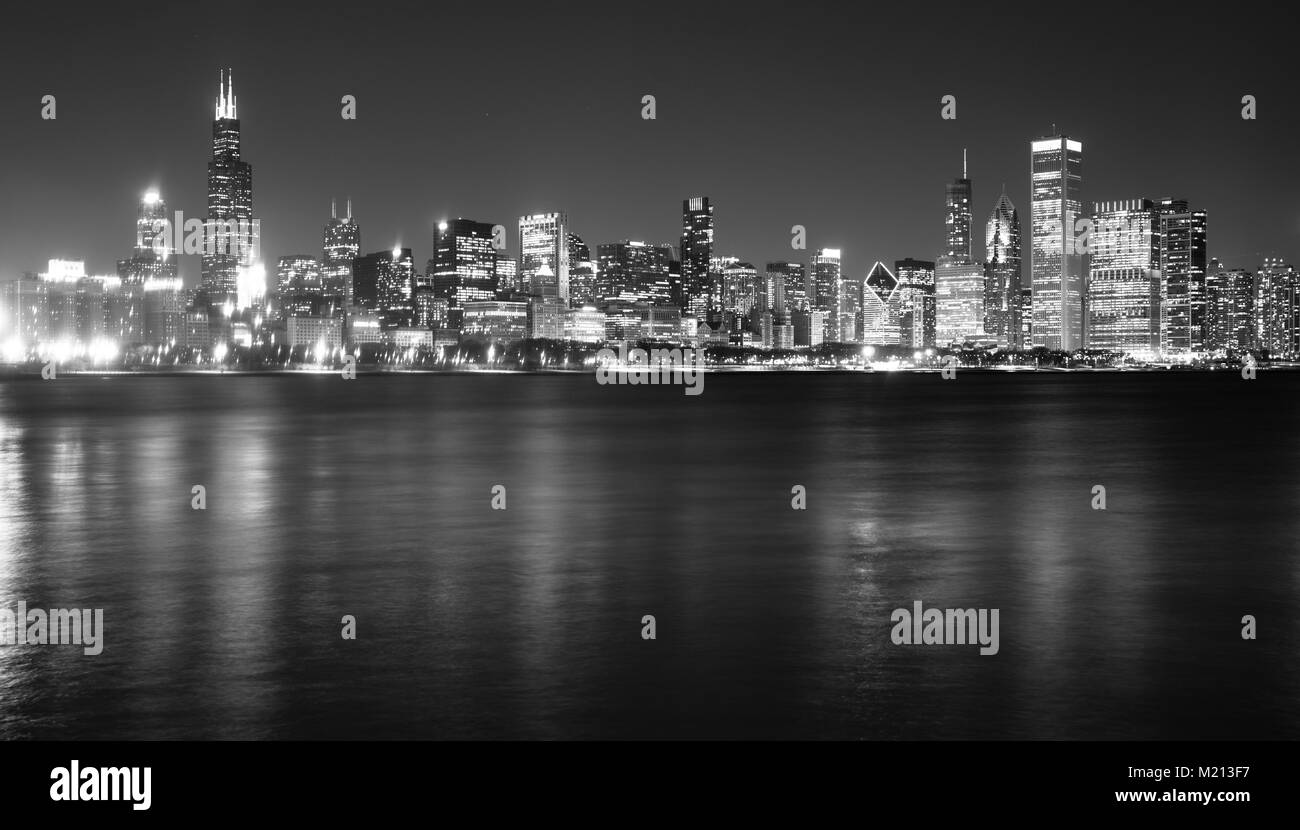 Waters of Lake Michigan reflect the light of tall buildings comprising ...