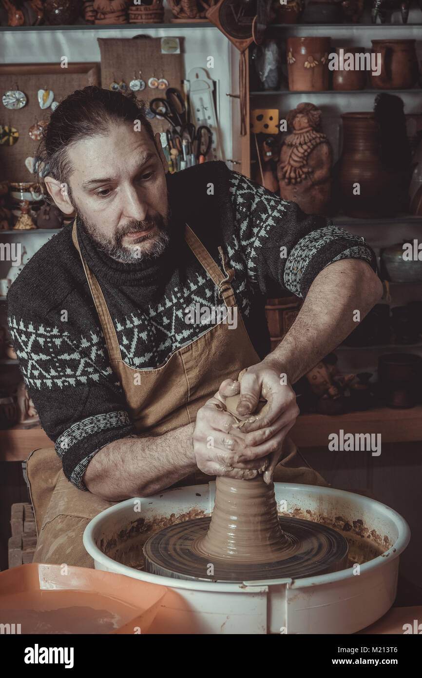 elderly man making pot using pottery wheel in studio Stock Photo - Alamy