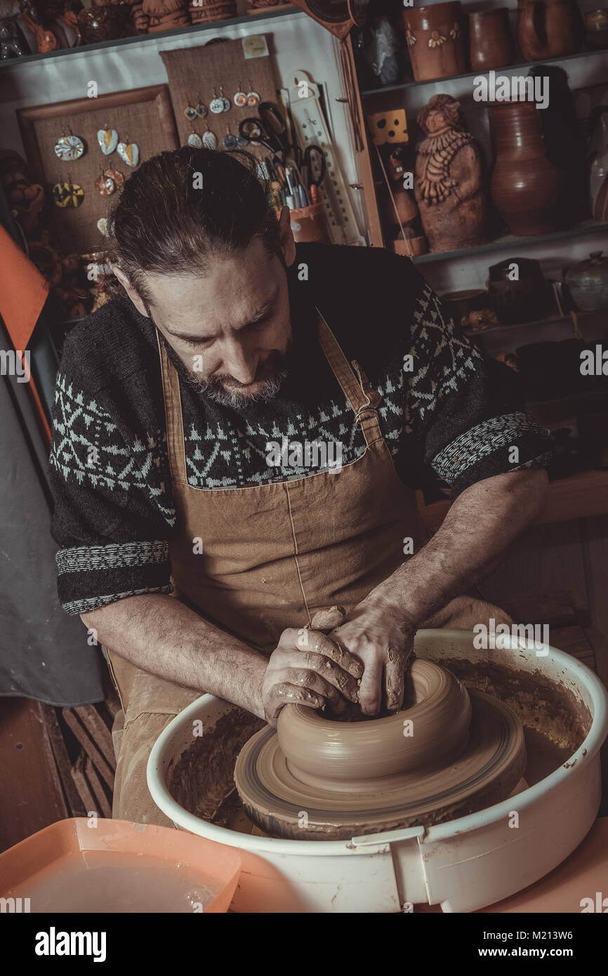 elderly man making pot using pottery wheel in studio Stock Photo - Alamy