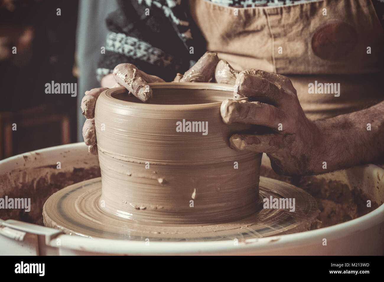 elderly man making pot using pottery wheel in studio Stock Photo - Alamy