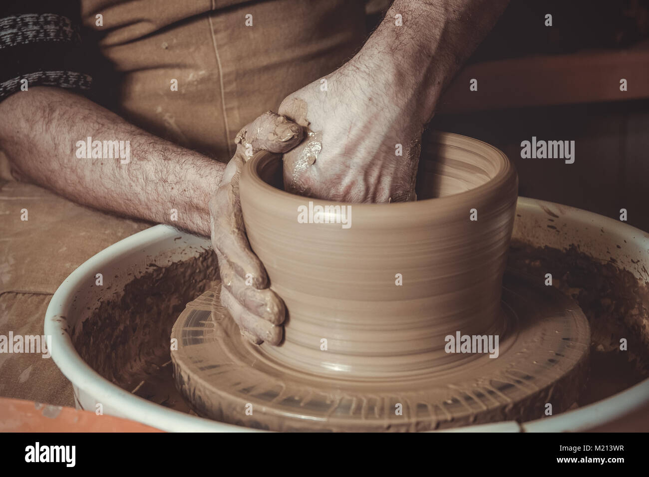 elderly man making pot using pottery wheel in studio Stock Photo - Alamy