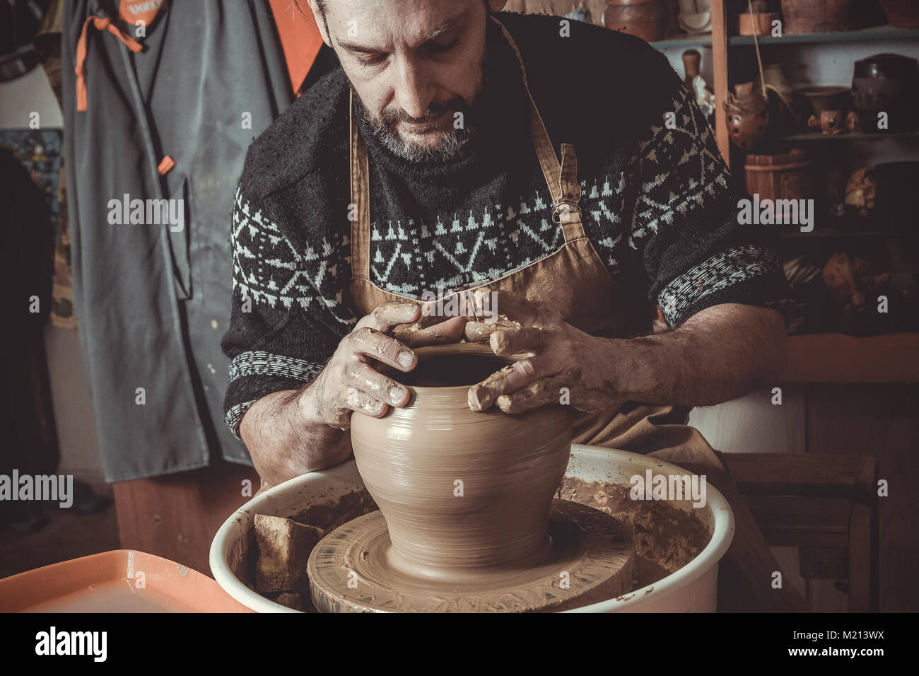elderly man making pot using pottery wheel in studio Stock Photo - Alamy