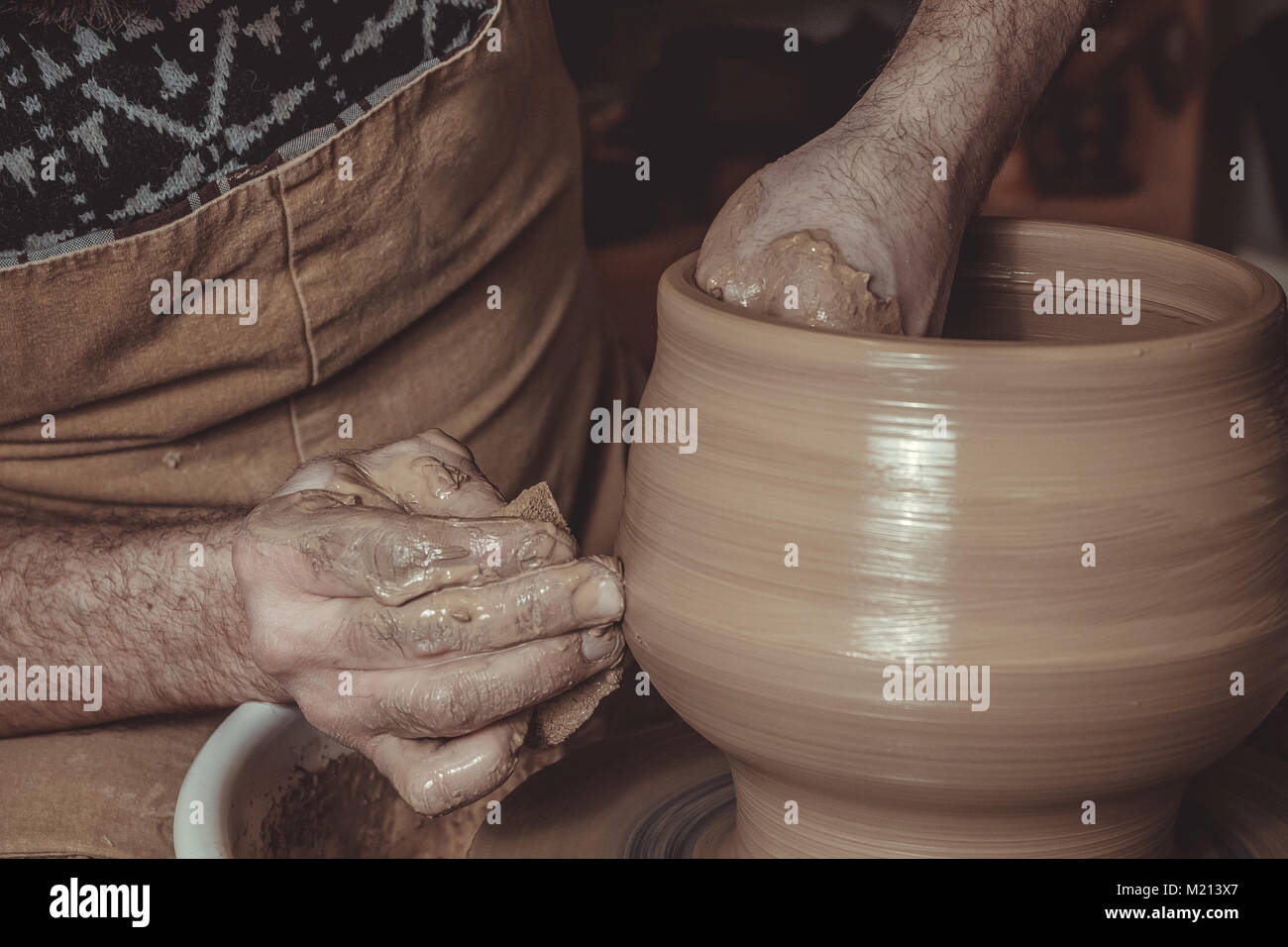 elderly man making pot using pottery wheel in studio Stock Photo - Alamy