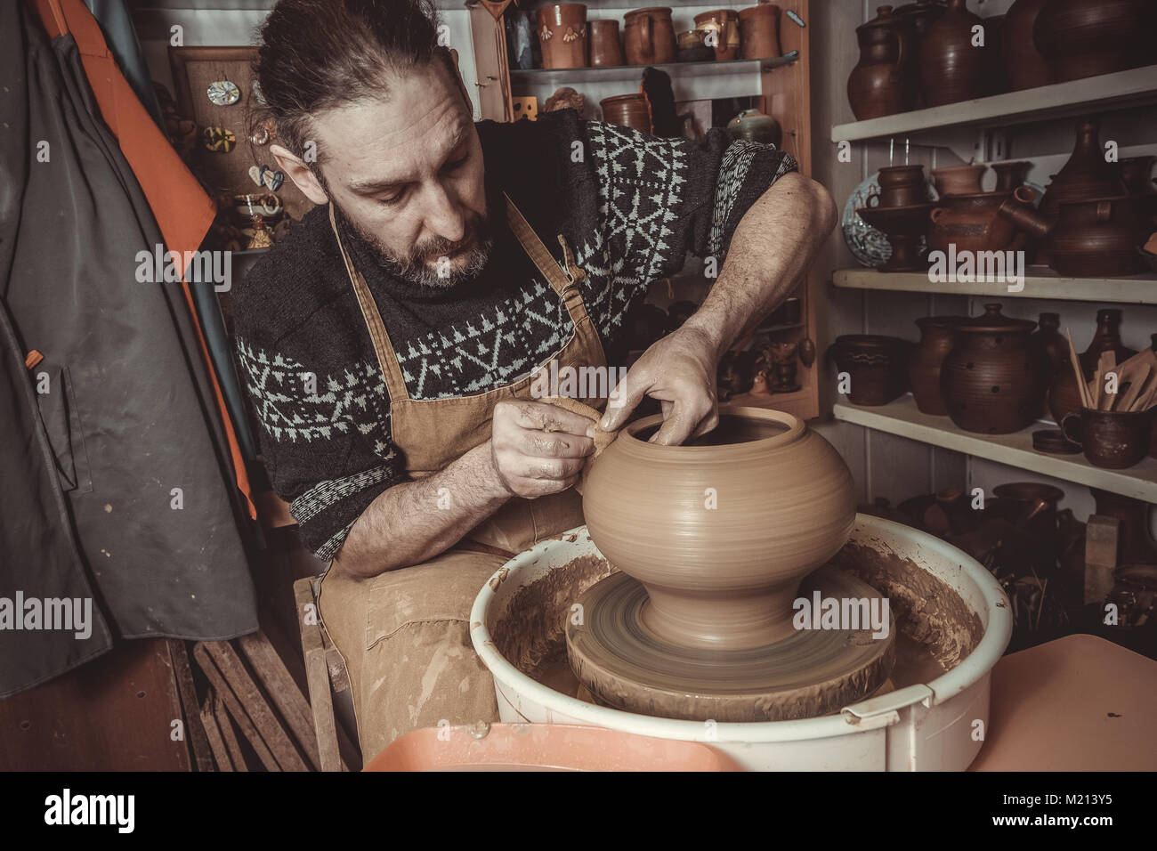 elderly man making pot using pottery wheel in studio Stock Photo - Alamy