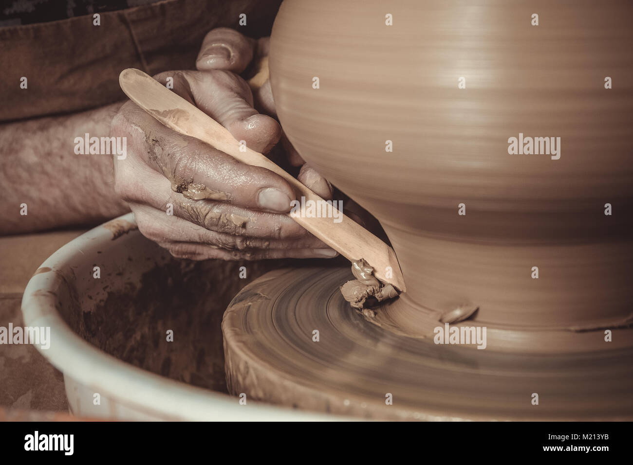 elderly man making pot using pottery wheel in studio Stock Photo - Alamy