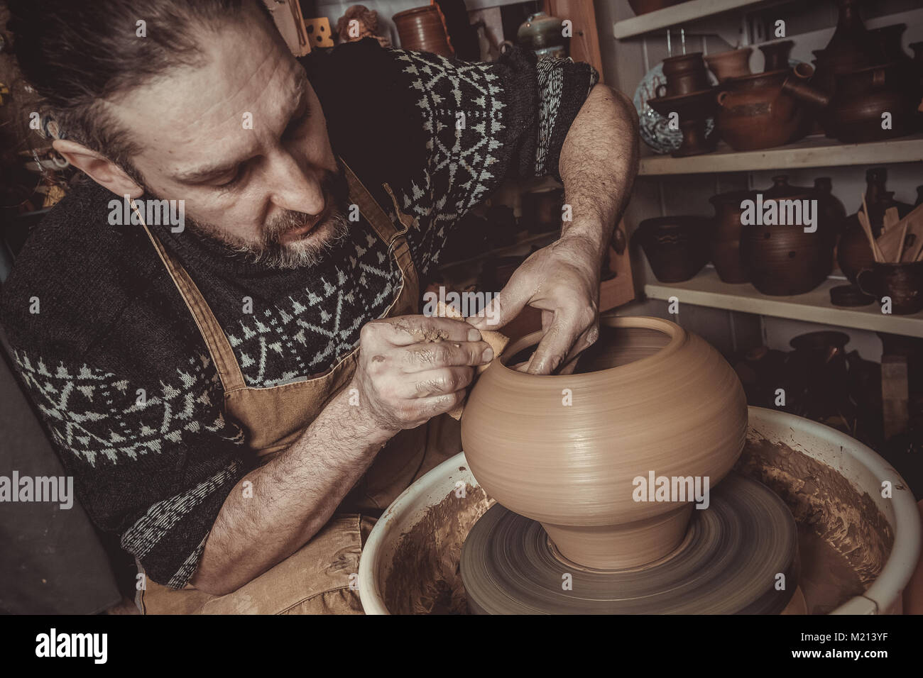 elderly man making pot using pottery wheel in studio Stock Photo - Alamy