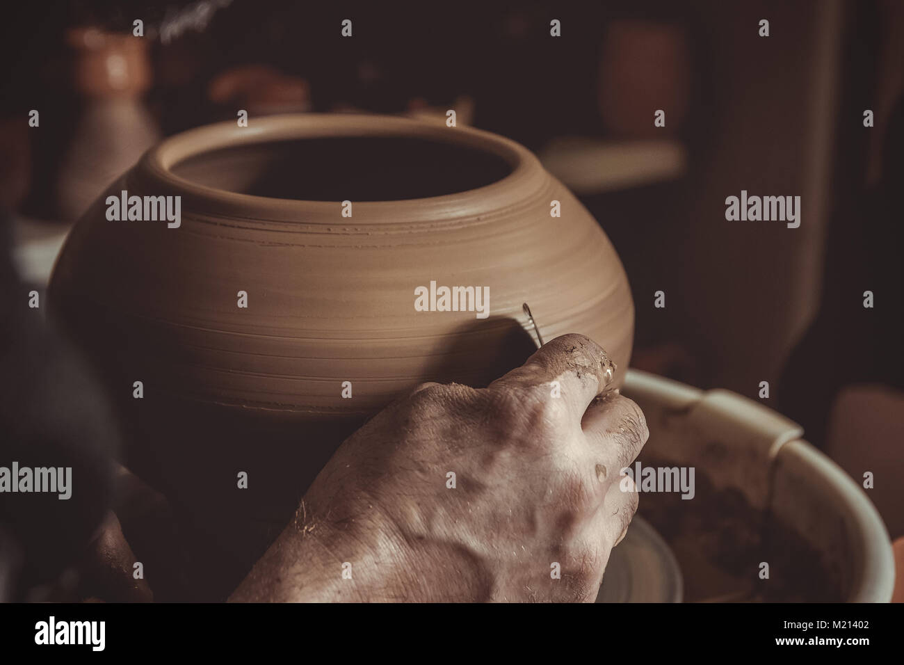 elderly man making pot using pottery wheel in studio Stock Photo - Alamy