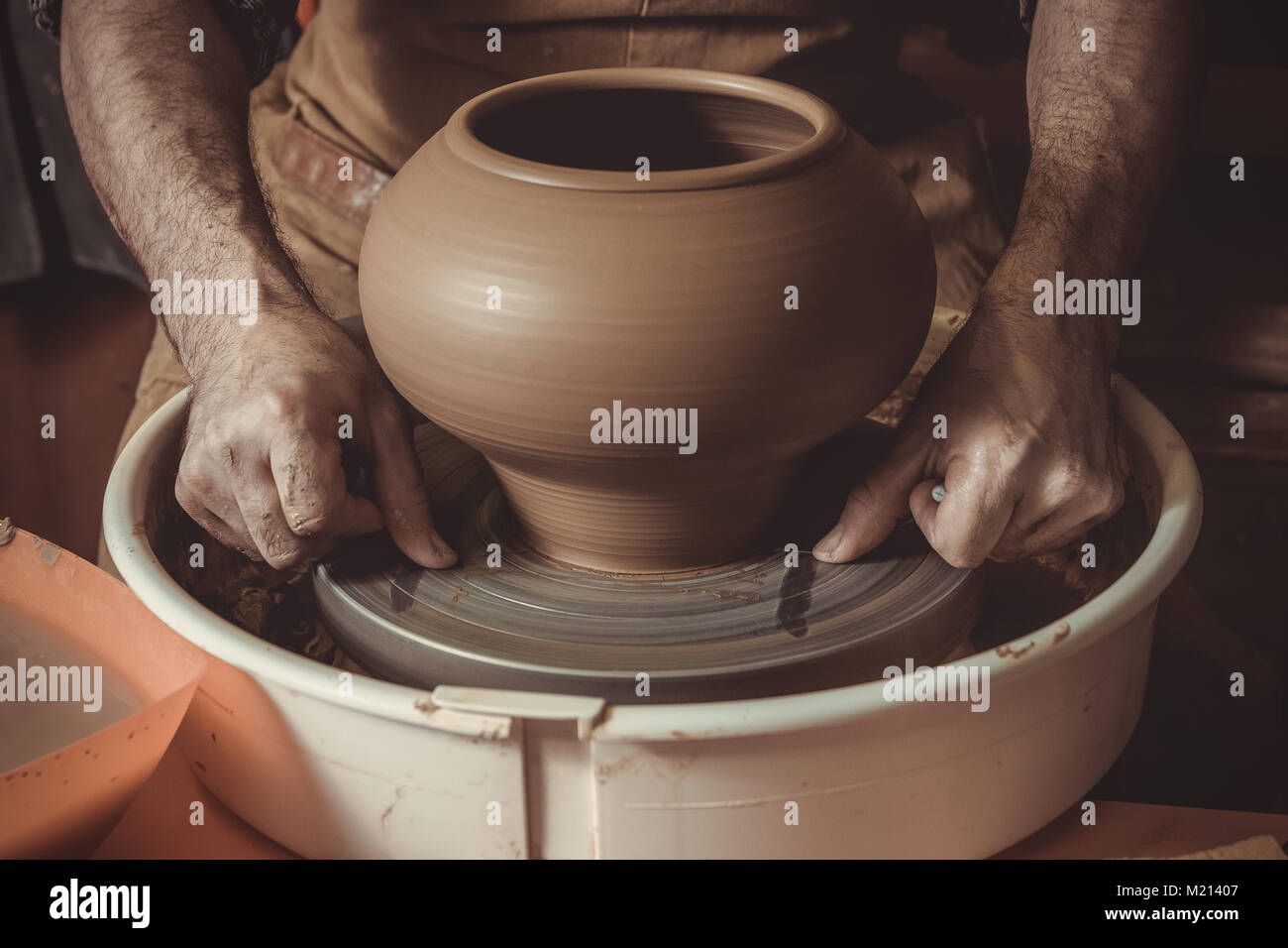 elderly man making pot using pottery wheel in studio Stock Photo - Alamy