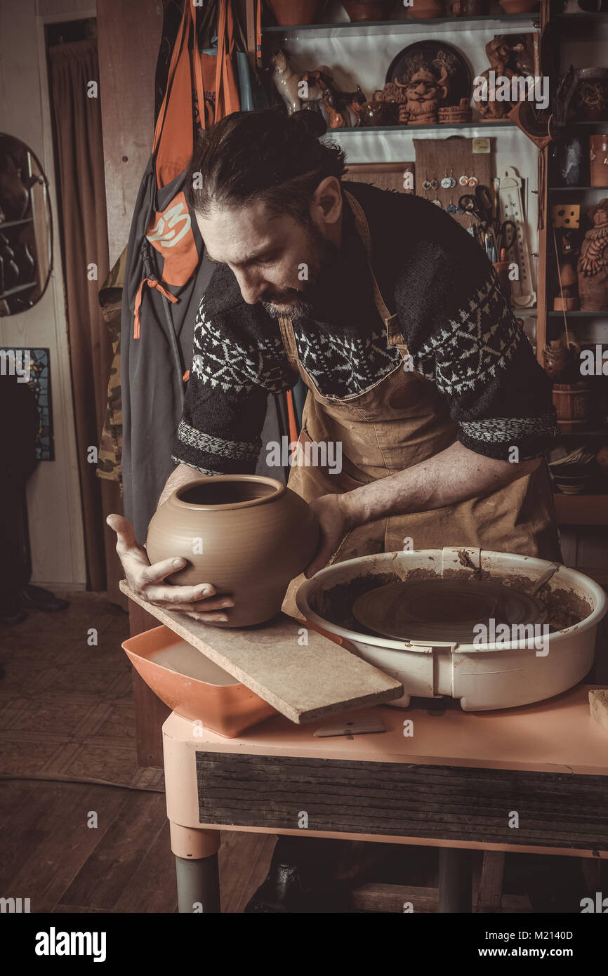 elderly man making pot using pottery wheel in studio Stock Photo - Alamy
