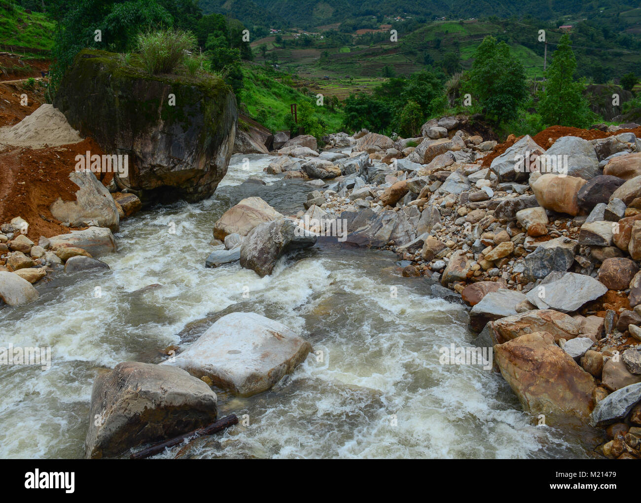 Strong and danger cold flowing river water with huge stone and rocks ...