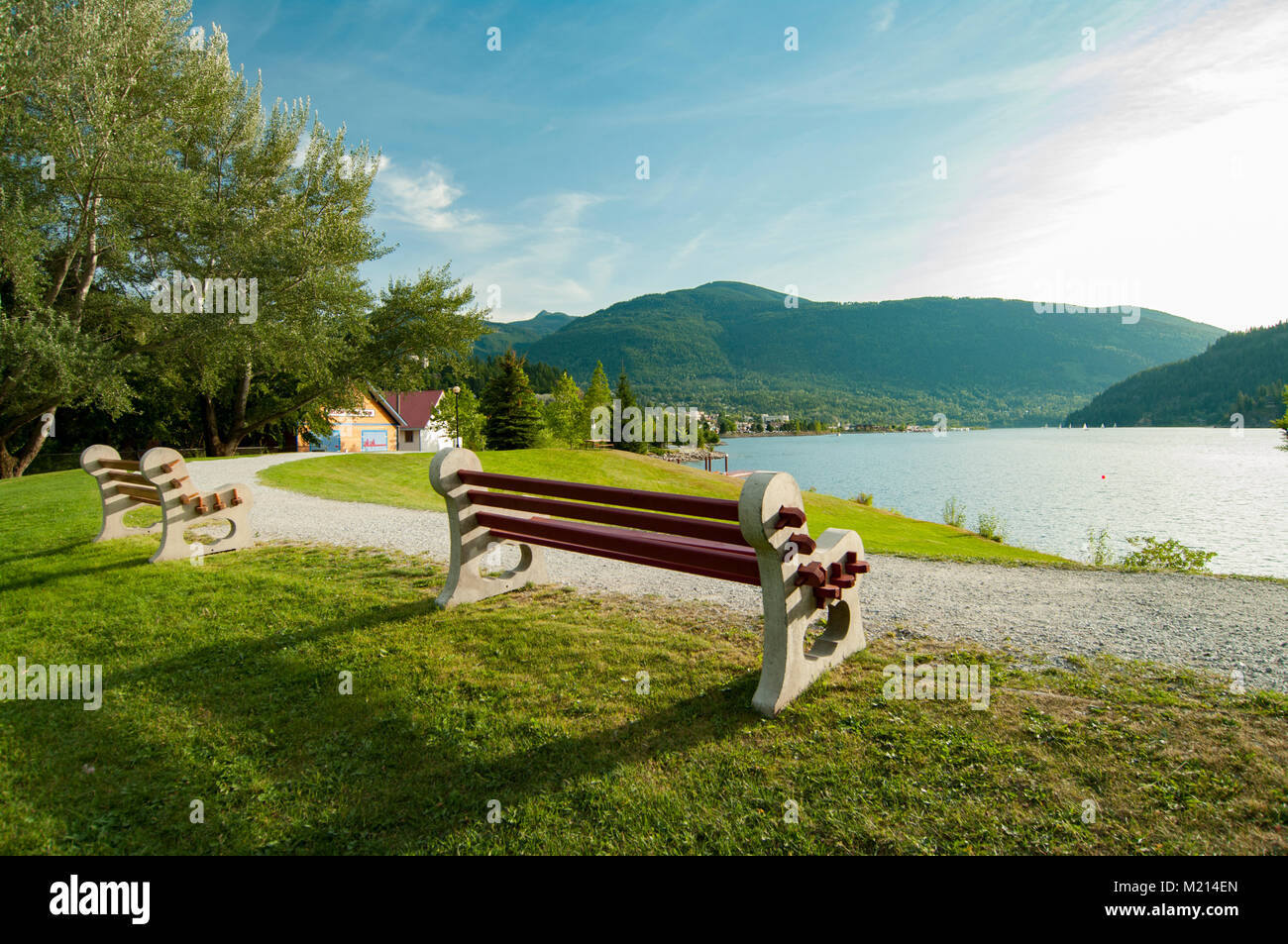 Nelson, British Columbia, Canada. Two sunlit park benches beside a ...