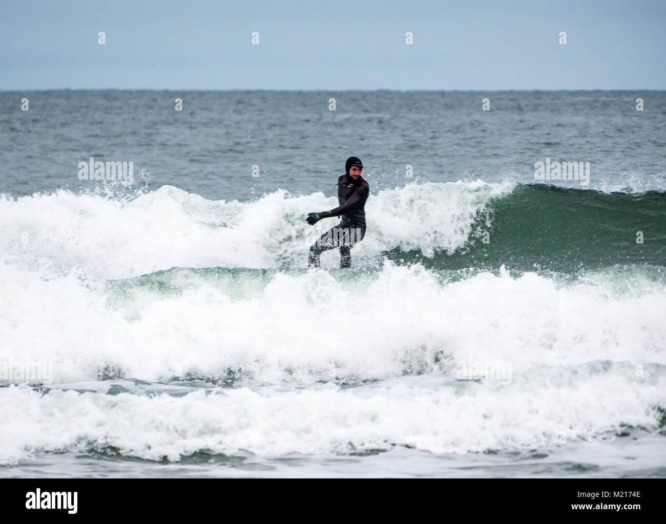Sandend, Aberdeenshire, Scotland, United Kingdom. A surfer out in cold ...