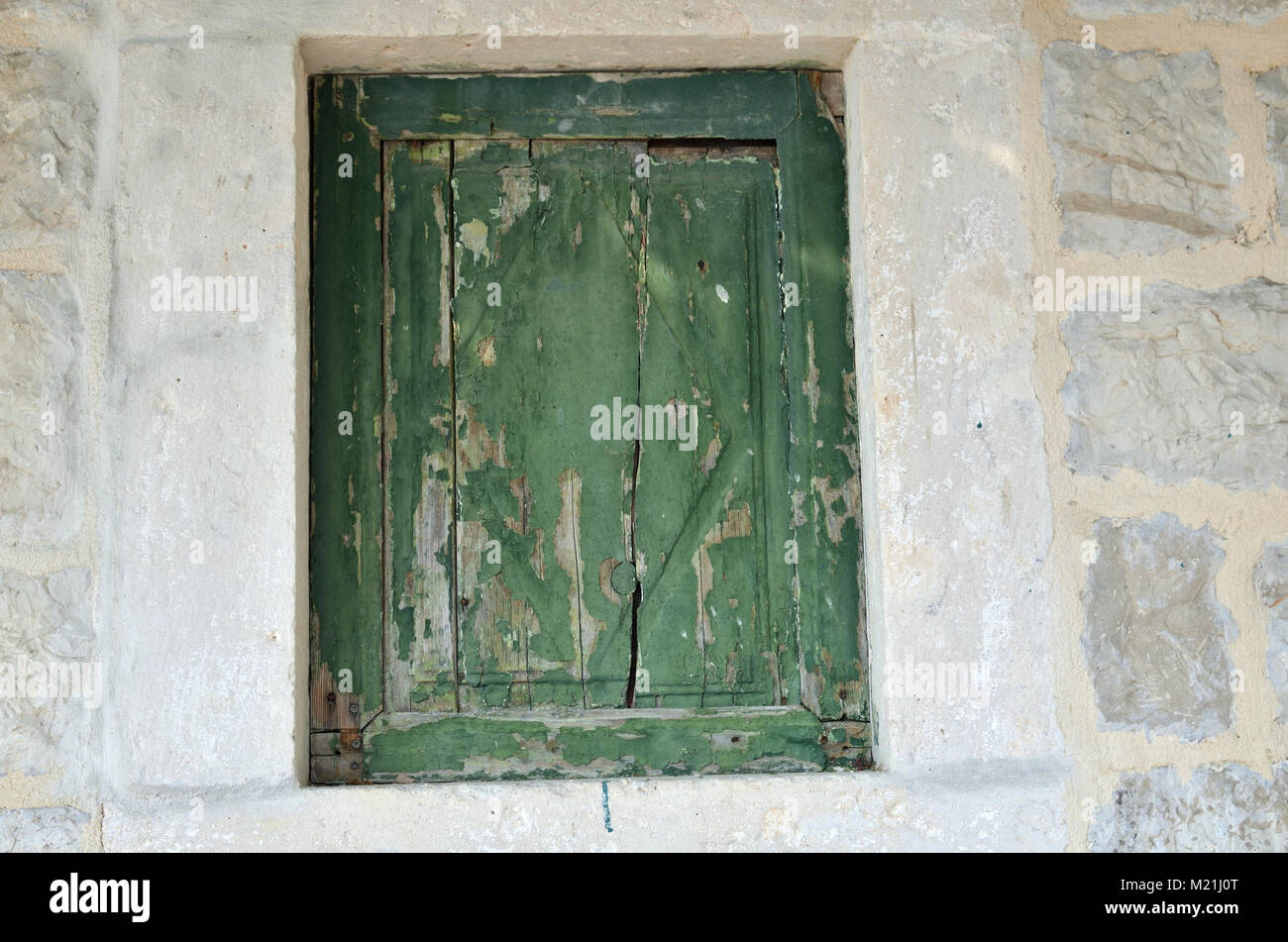 Old cracked green wooden shutter on a window Stock Photo - Alamy