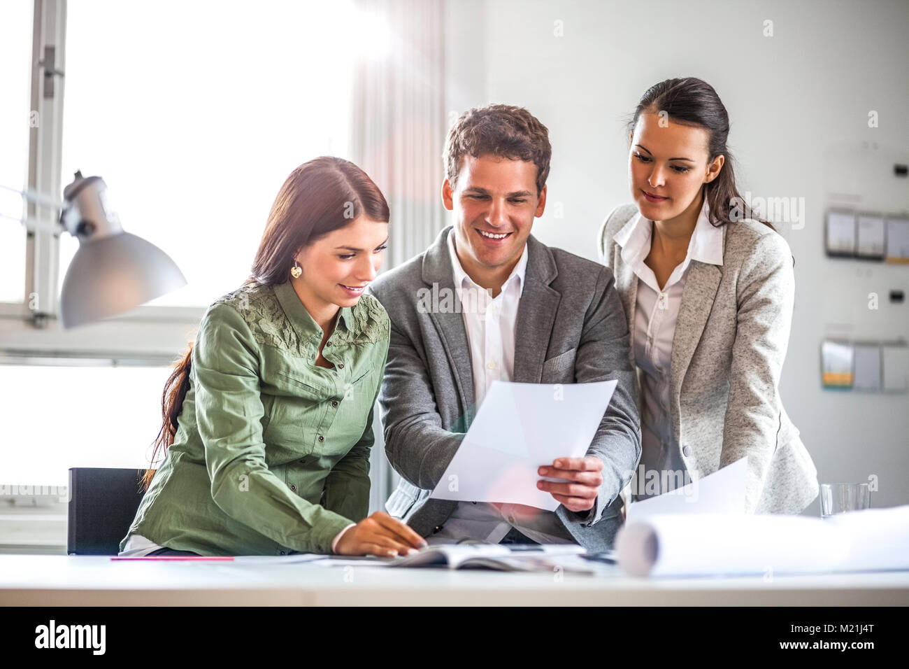 Business people reviewing documents in office Stock Photo - Alamy