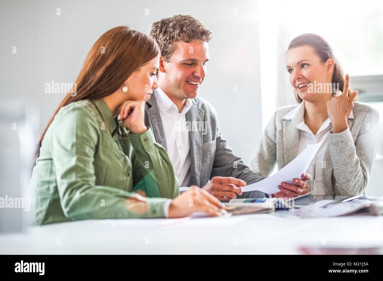 Business people analyzing document in office Stock Photo - Alamy