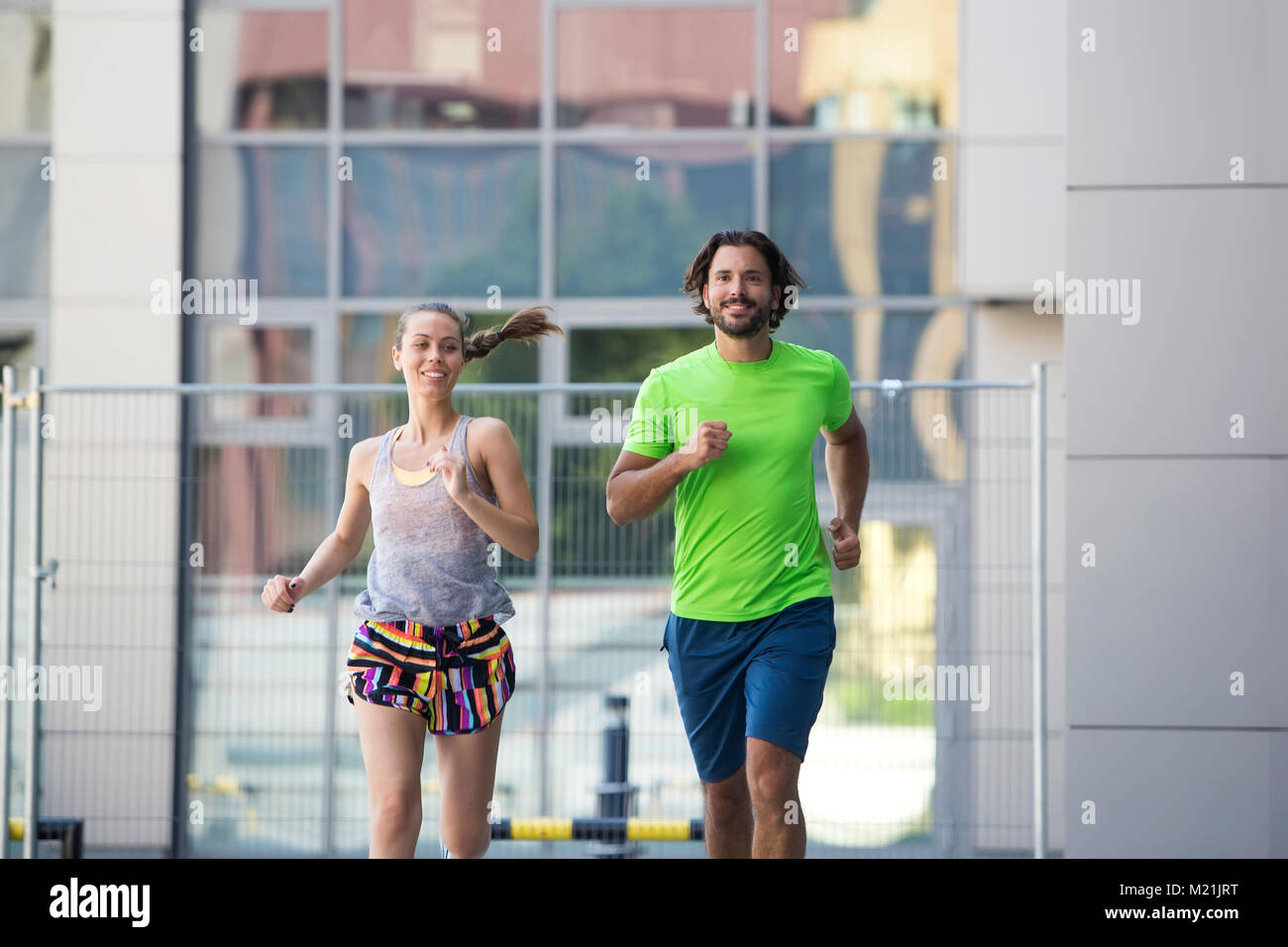 Couple running in urban enviroment at hot summer day Stock Photo - Alamy