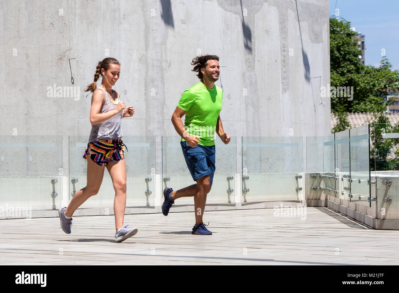 Couple running in urban enviroment at hot summer day Stock Photo - Alamy