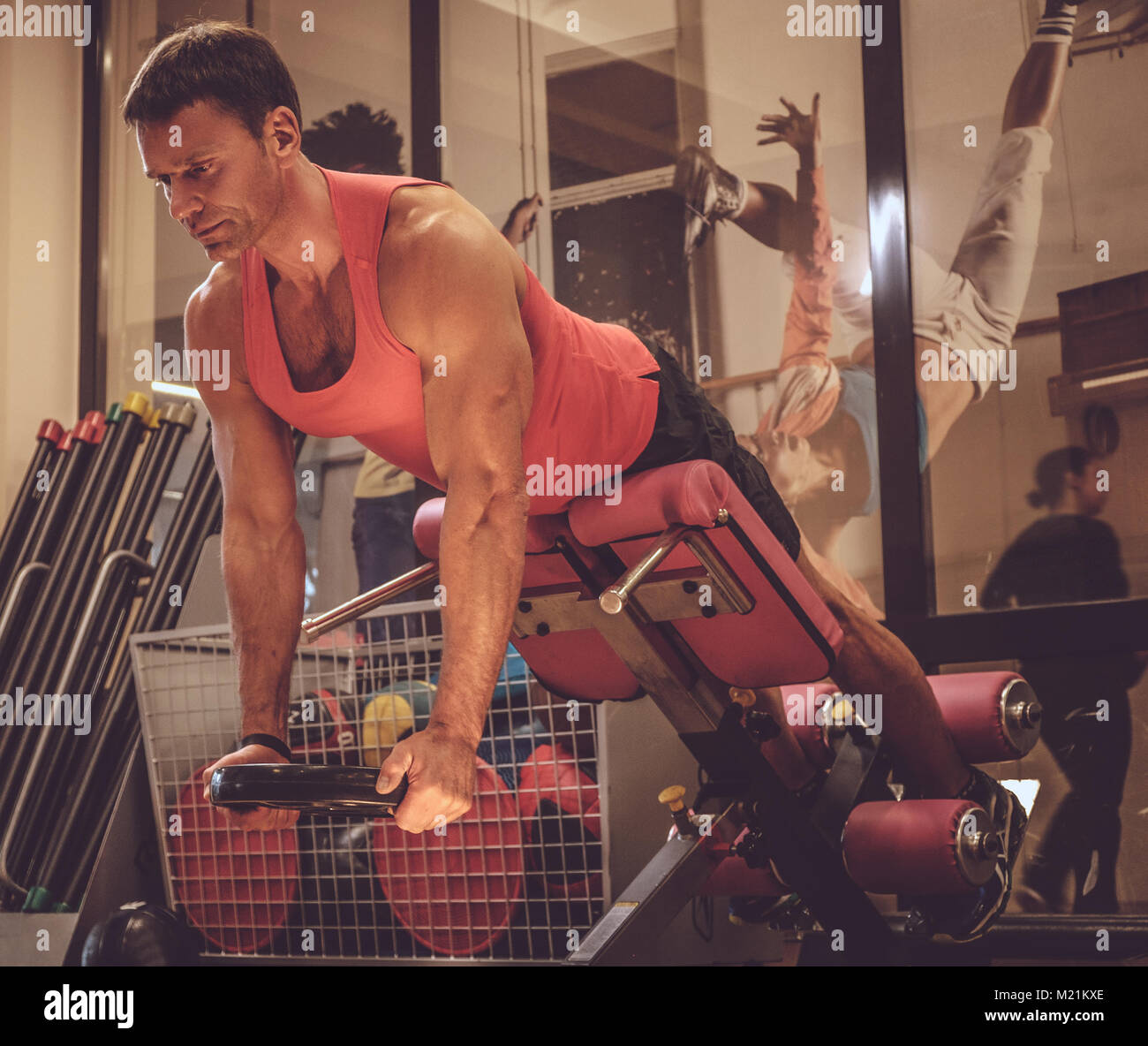 A man doing workouts in a gym club Stock Photo - Alamy
