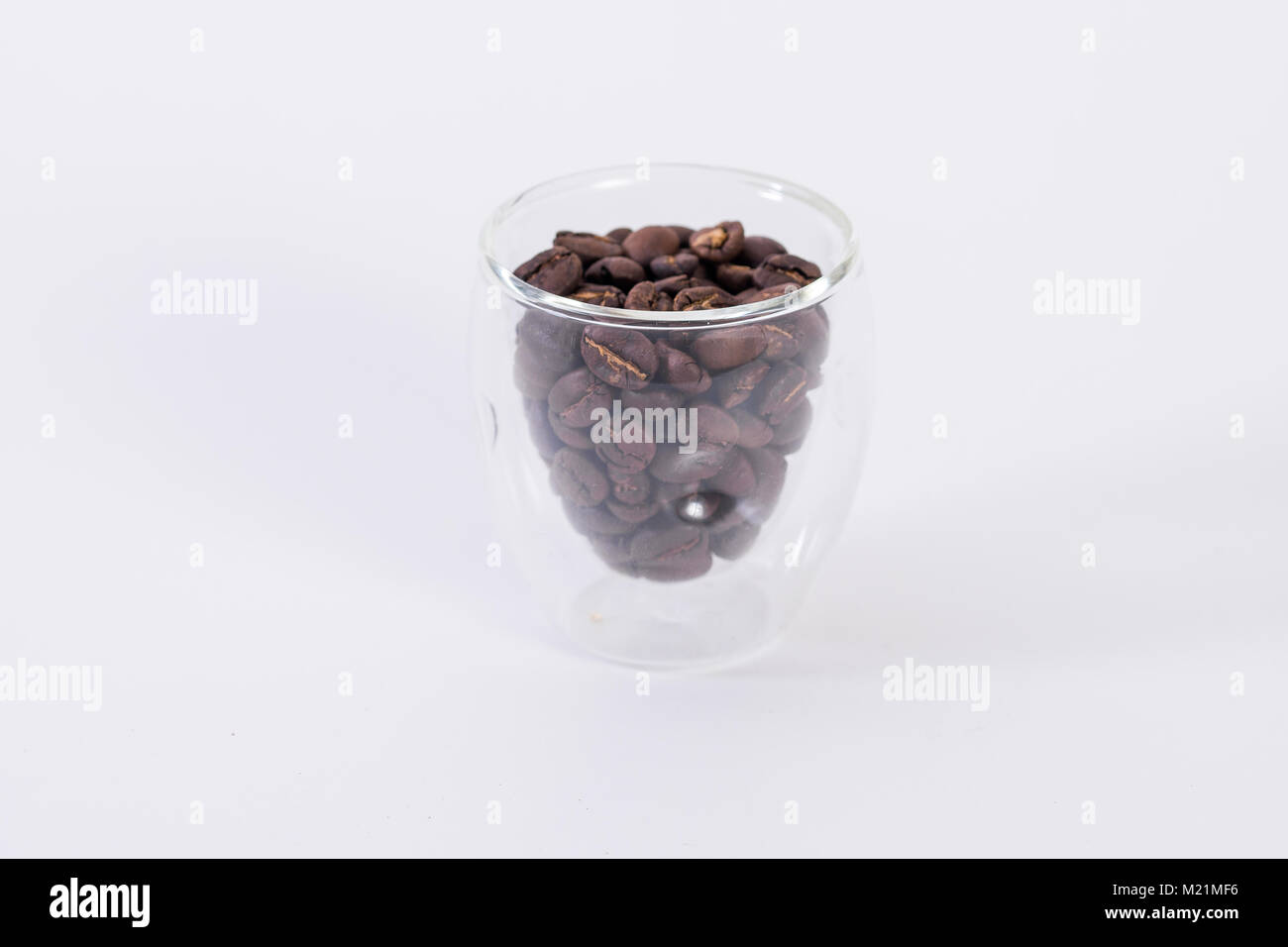 Coffee beans in a coffee or espresso cup, plain white background Stock ...