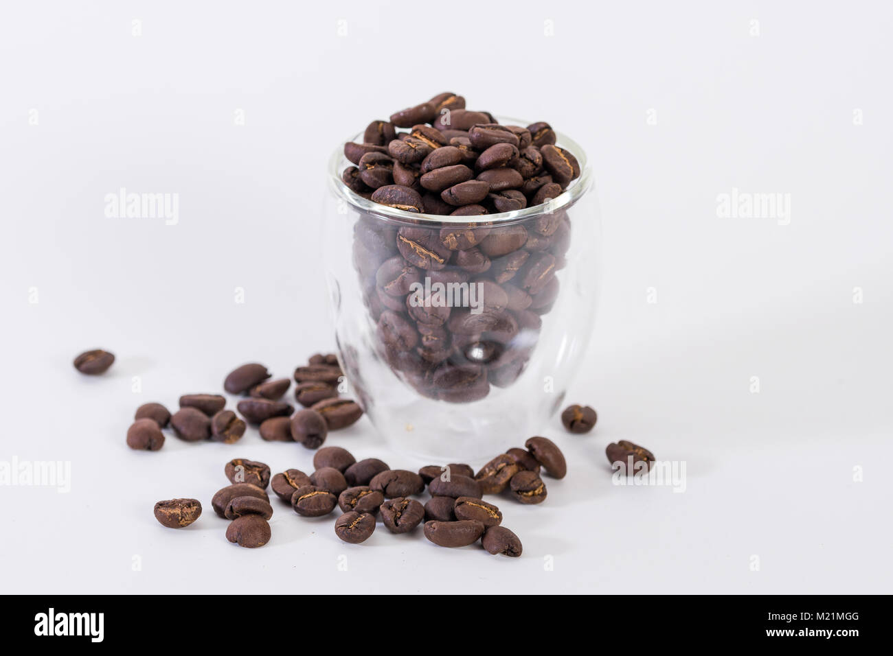 Coffee beans in a coffee or espresso cup, plain white background Stock ...