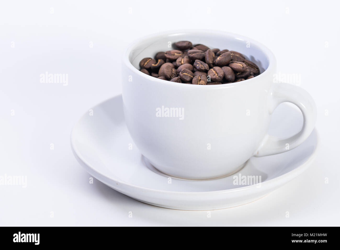 Coffee beans in a coffee or espresso cup, plain white background Stock ...