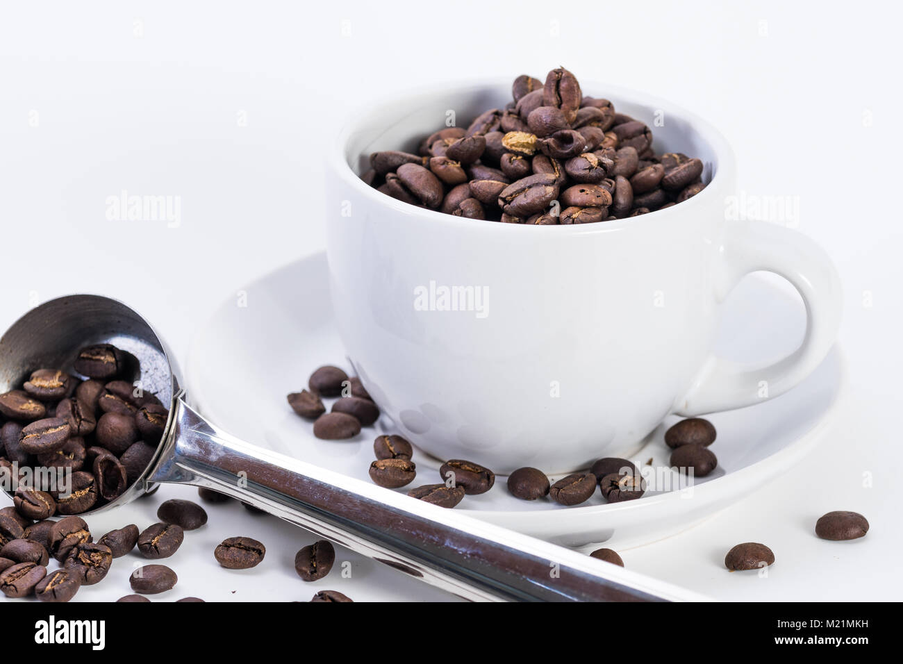 Coffee beans in a coffee or espresso cup, plain white background Stock ...