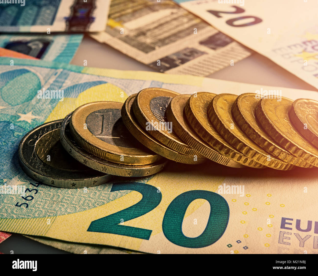 paper euro banknotes and coins. The coin is one euro. Currency of the ...