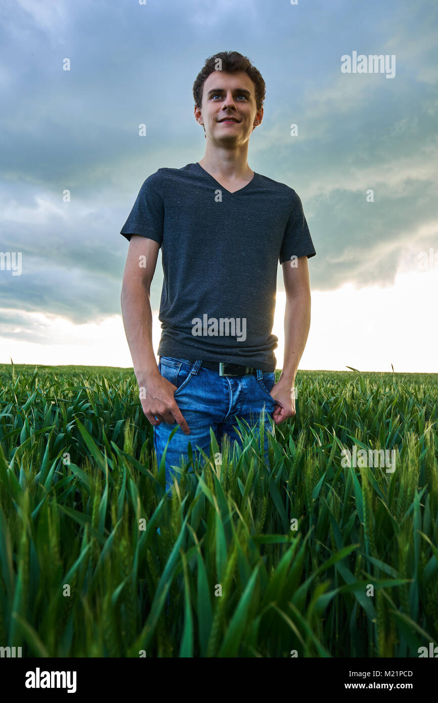 Portrait of a country boy standing in a wheat field at sunset Stock ...