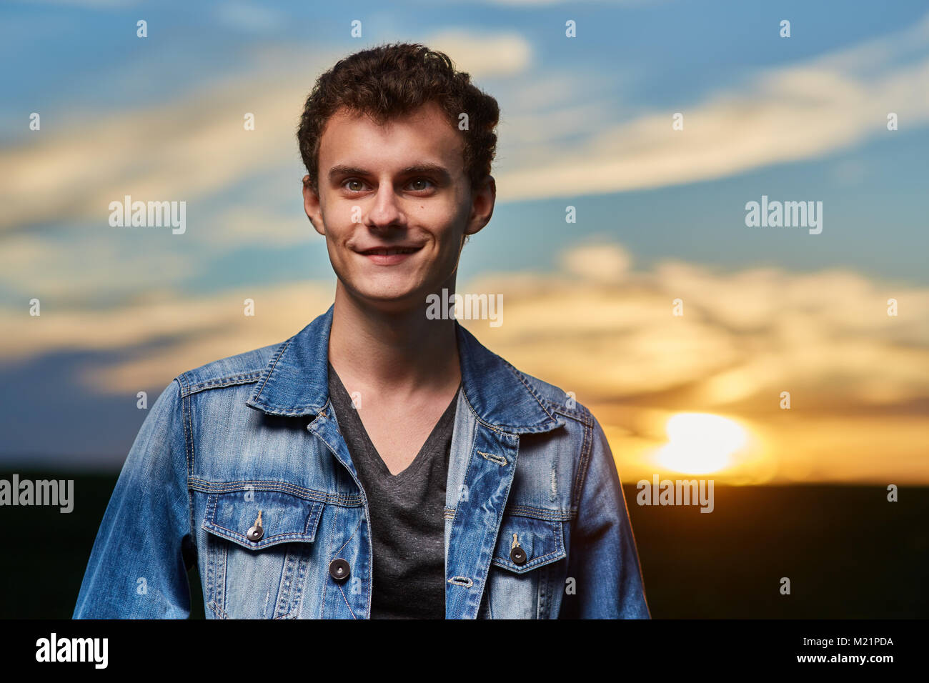 Portrait of a country boy standing in a wheat field at sunset Stock ...