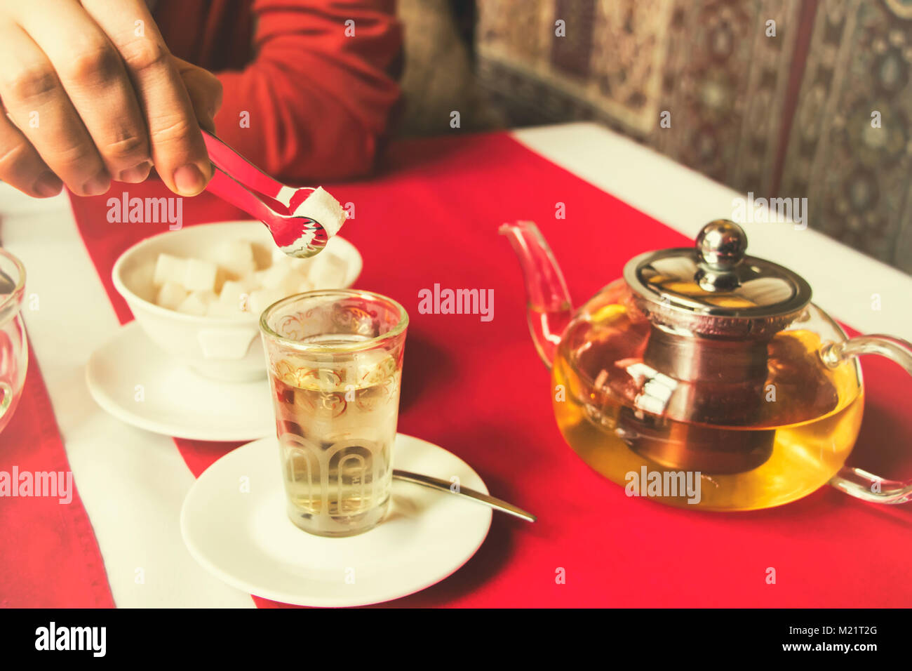 man puts sugar in tea, restaurant,East style Stock Photo - Alamy