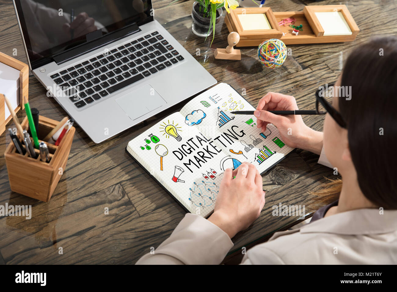 Close-up Of A Businesswoman Drawing Digital Marketing Chart On Notebook ...