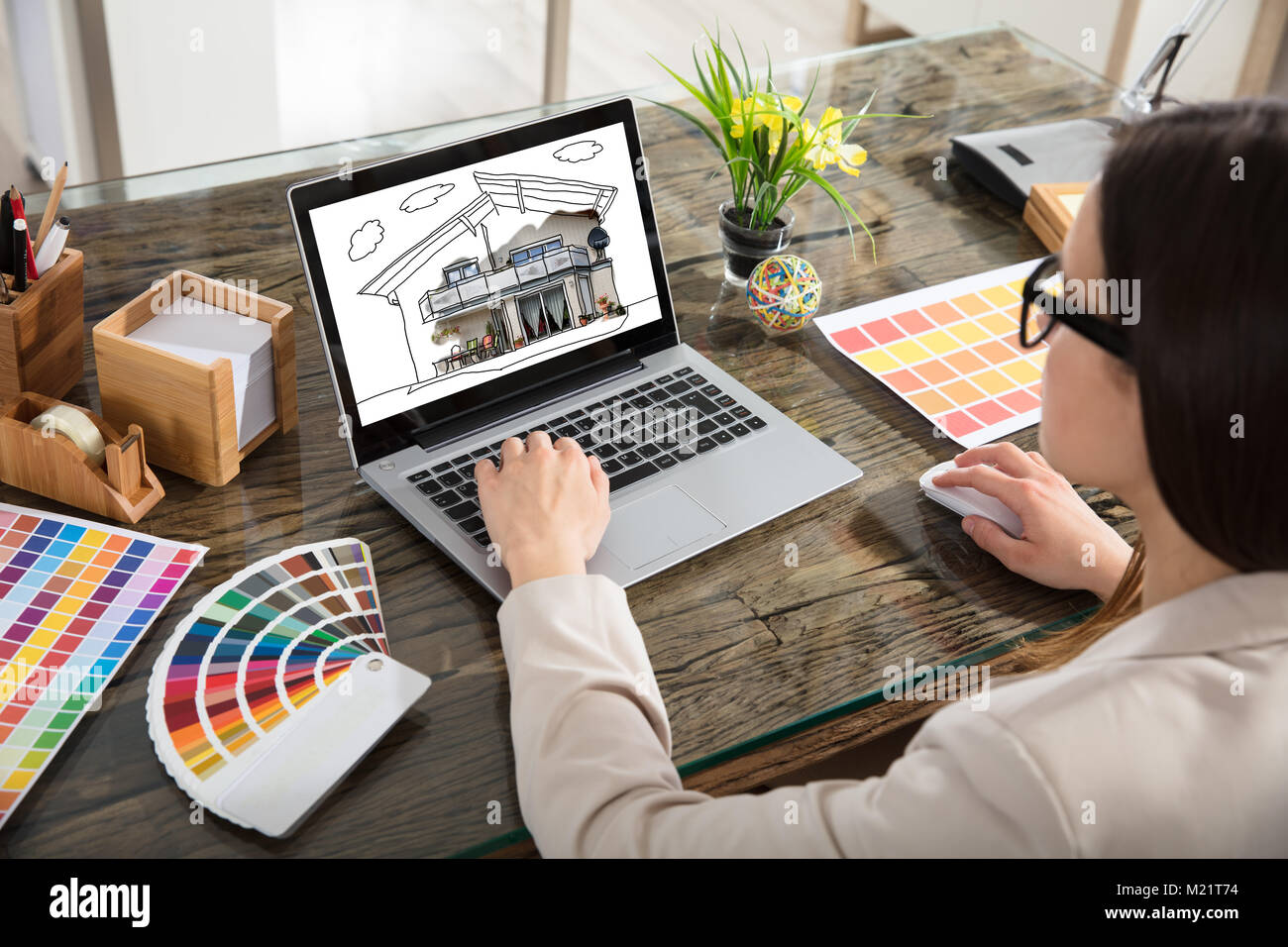 An Architect Working With Color Samples For Selection Using Laptop ...