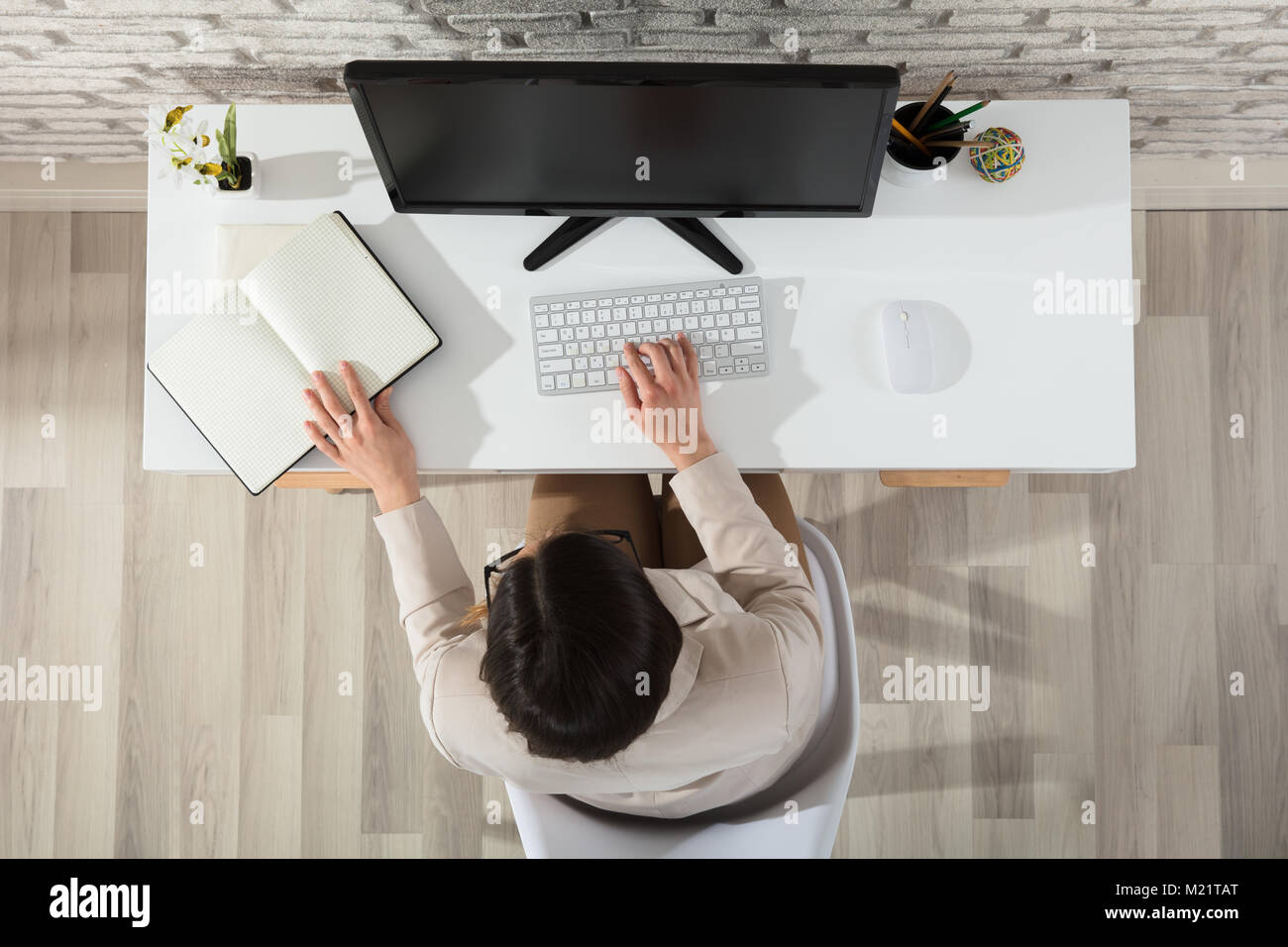 Elevated View Of A Businesswoman Using Computer At Workplace In Office ...