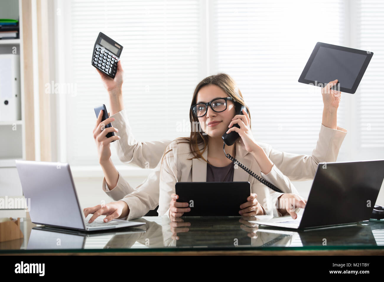 Woman multitasking arms hi-res stock photography and images - Alamy