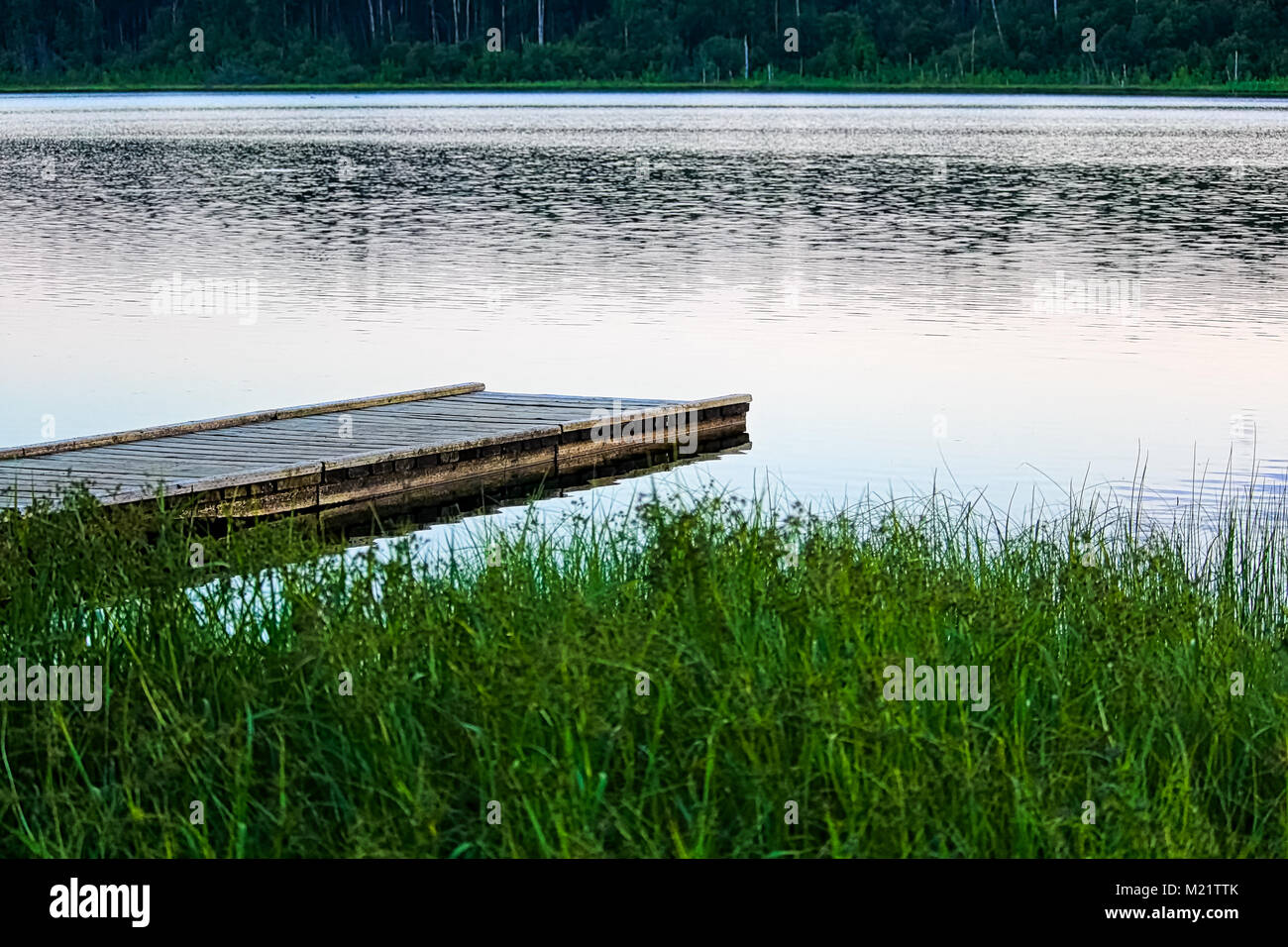 A boat dock at a quiet summer lake Stock Photo - Alamy