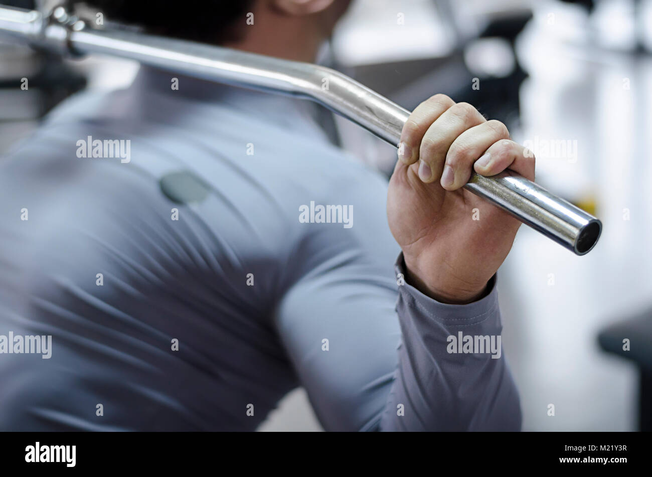 Closeup shot of male hand holding pulldown machine handle, workout in ...