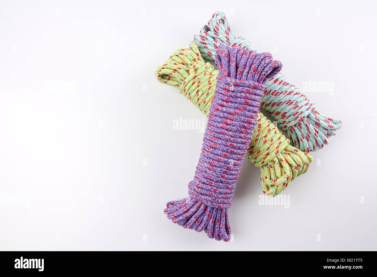 Various colour of ropes isolated on white background Stock Photo - Alamy