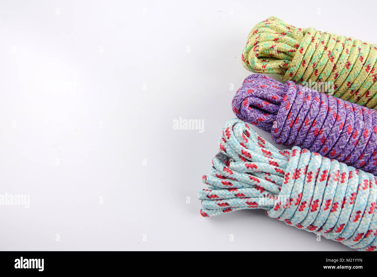Various colour of ropes isolated on white background Stock Photo - Alamy