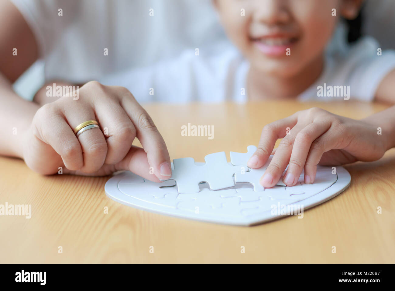 Asian family doing jigsaw puzzle hi-res stock photography and images ...
