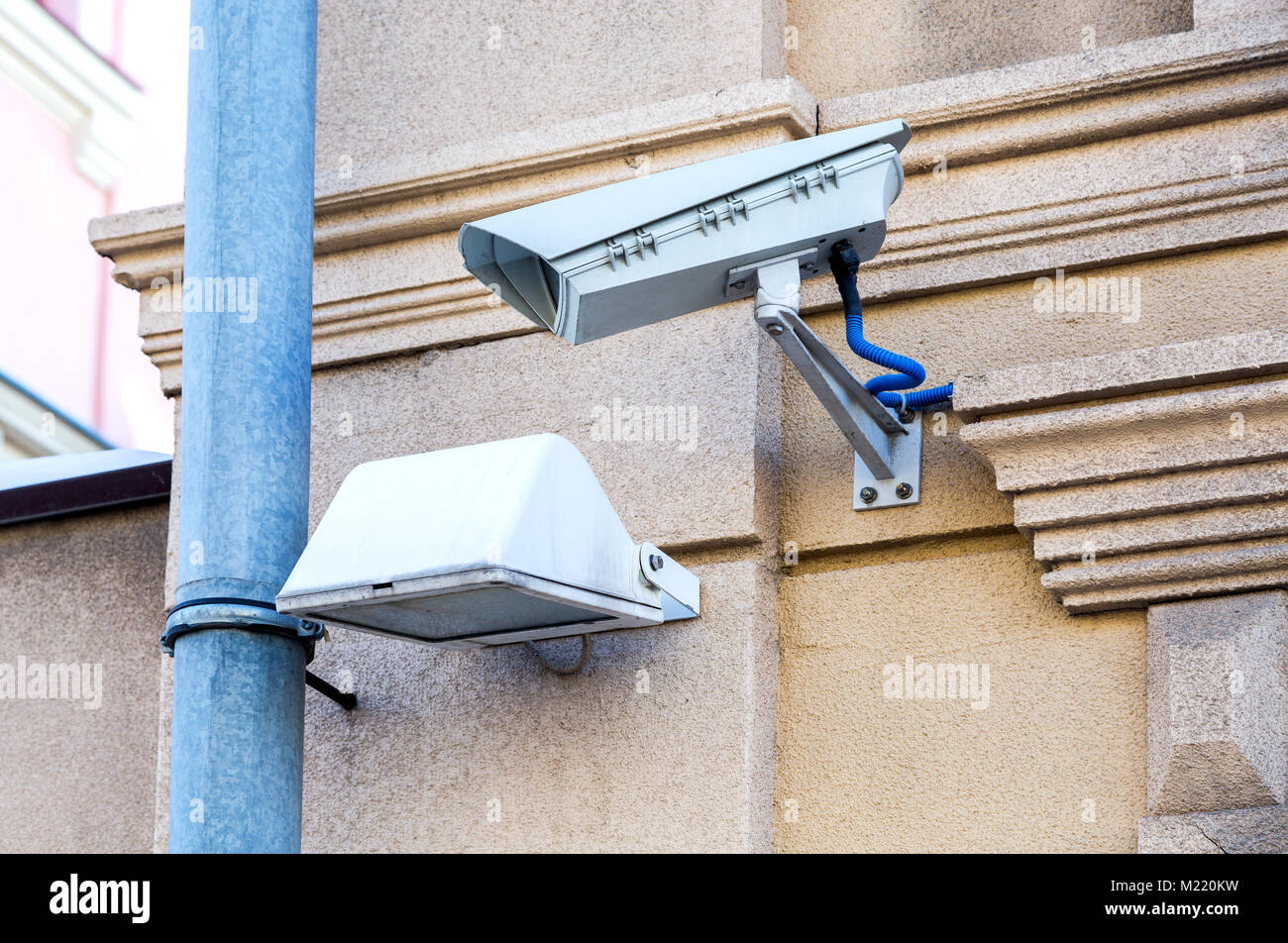 Surveillance camera mounted on the wall of the building Stock Photo - Alamy