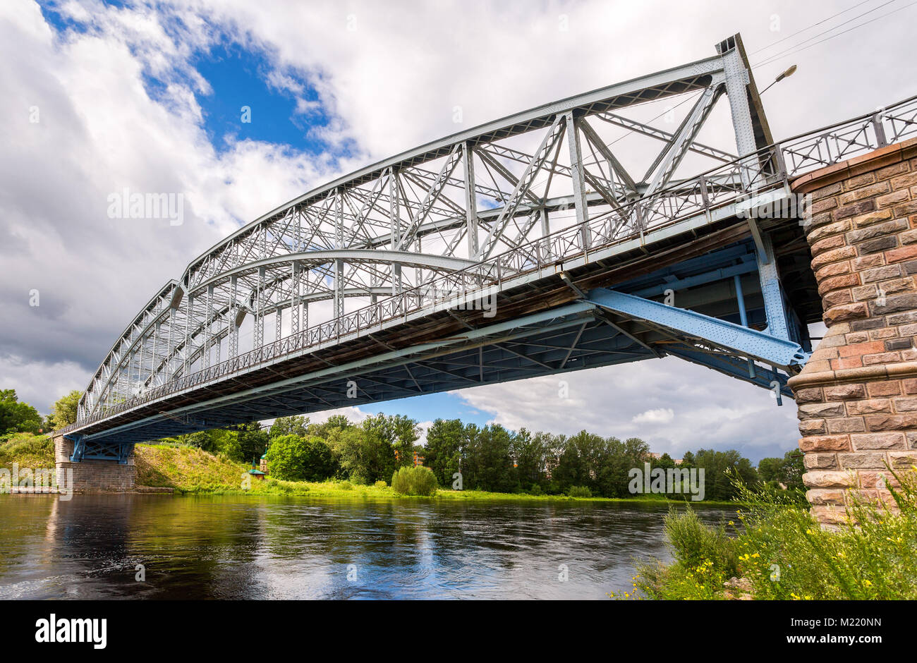 First in Russia steel arch bridge on river Msta in sunny summer day ...