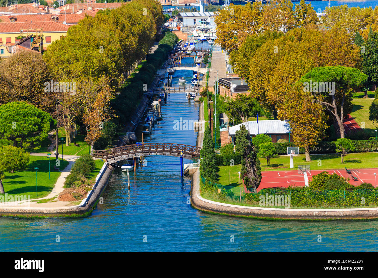 Tree Lined Canal in Venice with Bridges and Boats Stock Photo - Alamy