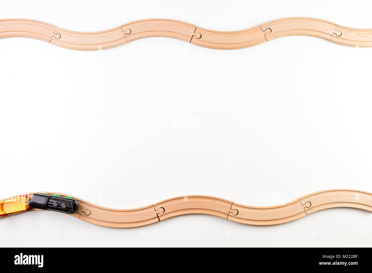 Toy train and curve wooden railways on white background Stock Photo - Alamy