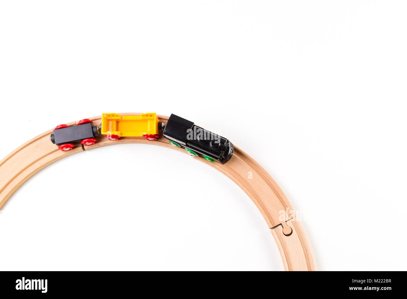 Toy train on curve wooden railways. Top view Stock Photo - Alamy