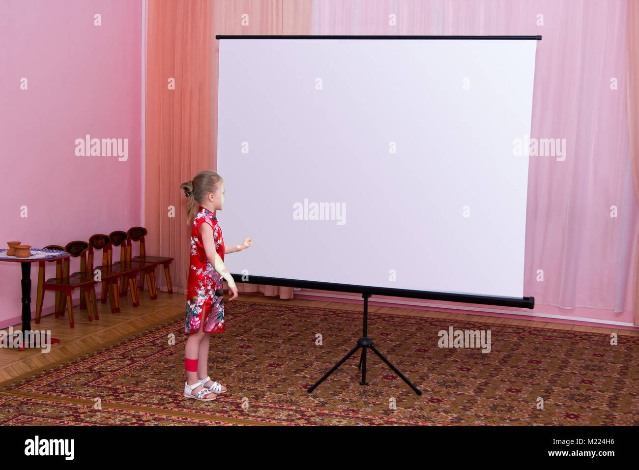 little girl shows a presentation on the screen Stock Photo - Alamy
