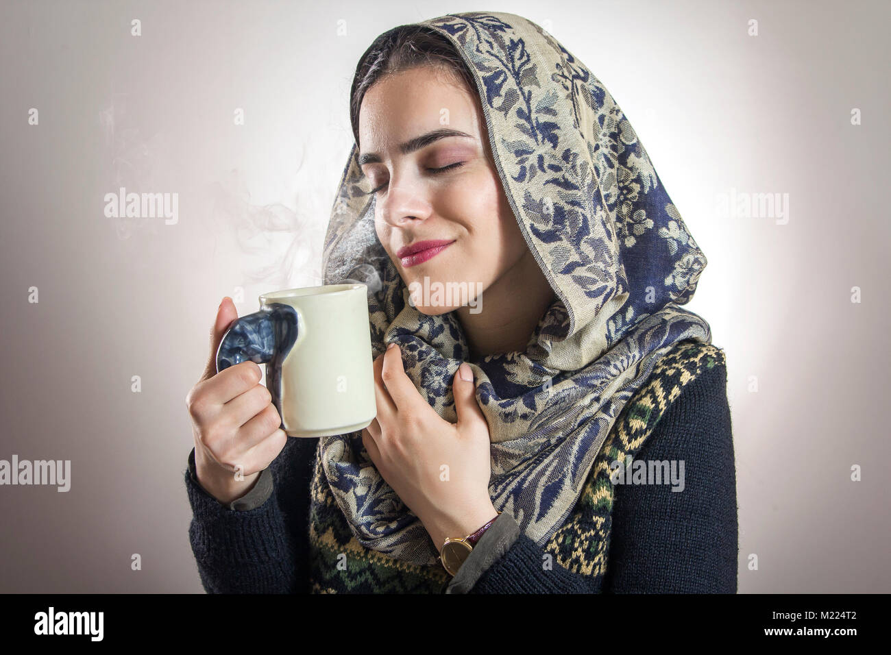Young woman smelling her coffee Stock Photo - Alamy