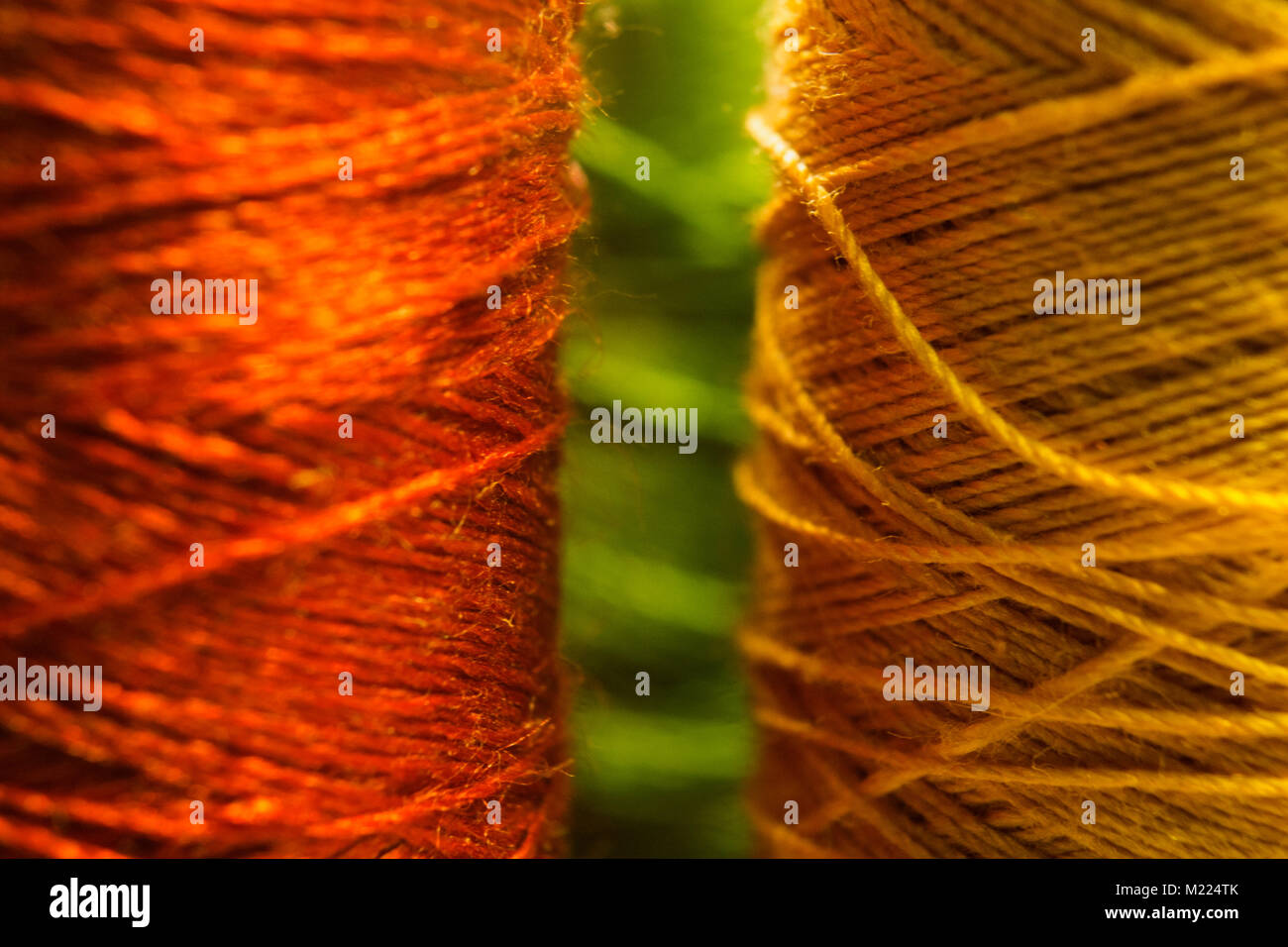 Red and yellow sewing thread spools shot close-up Stock Photo - Alamy