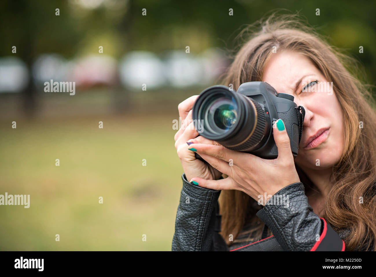 Female photographer shooting outdoors Stock Photo - Alamy