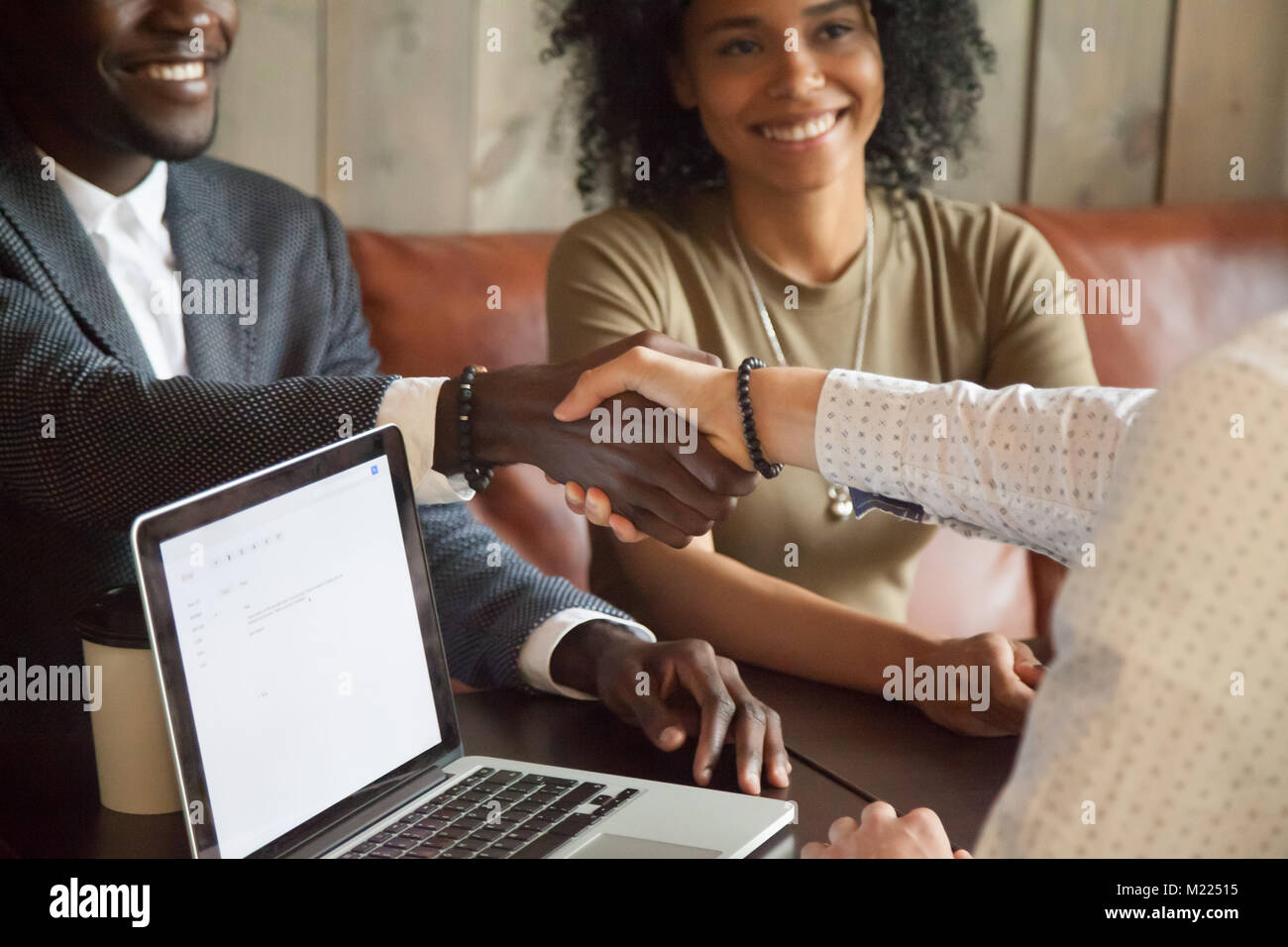 Happy african american couple making deal handshaking caucasian Stock ...